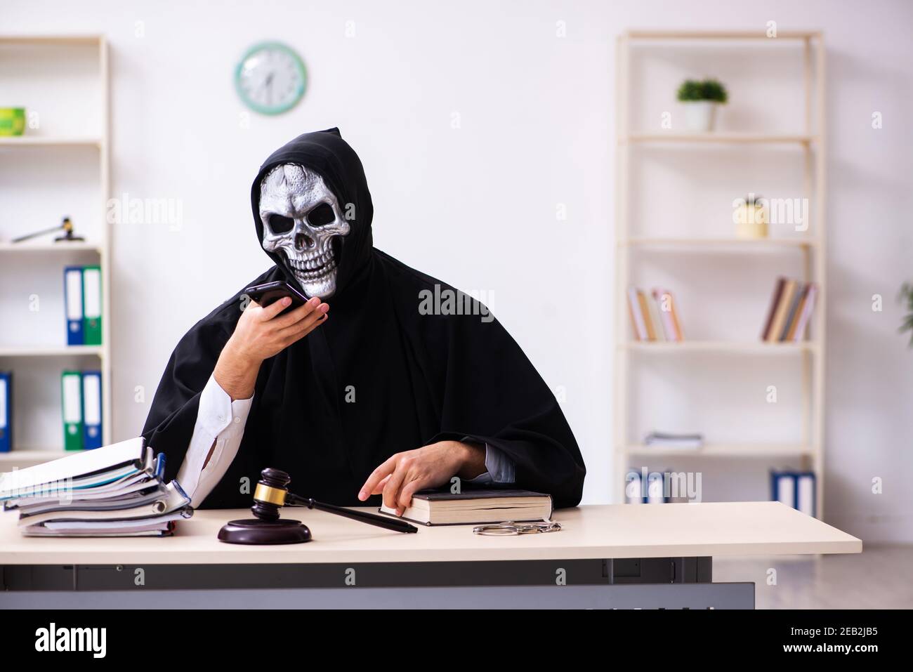 Devil judge working in the courthouse Stock Photo - Alamy