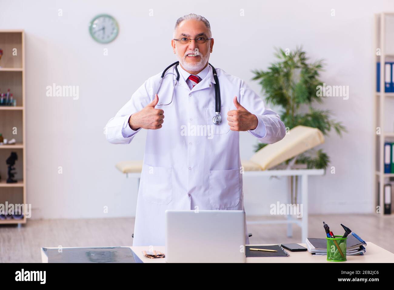 Old doctor working in the clinic Stock Photo - Alamy