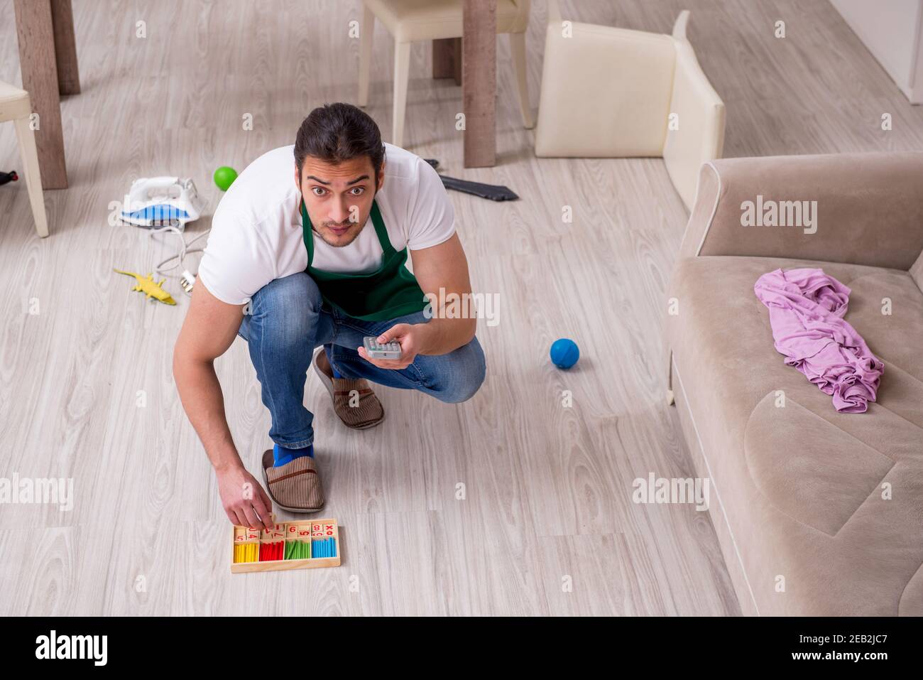Young contractor cleaning the flat after kids' party Stock Photo - Alamy