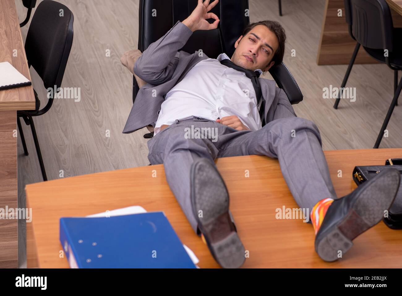 Young employee sleeping at workplace Stock Photo - Alamy