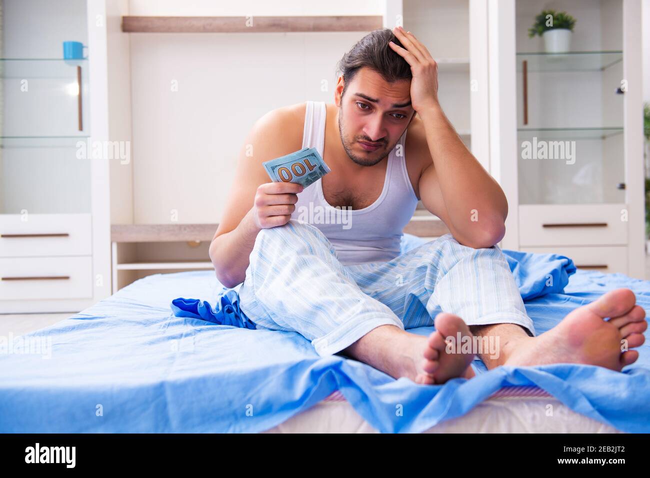Young man in insolvency concept Stock Photo - Alamy