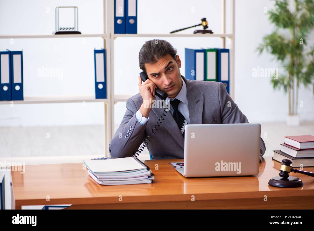 Young lawyer sitting in the office Stock Photo - Alamy