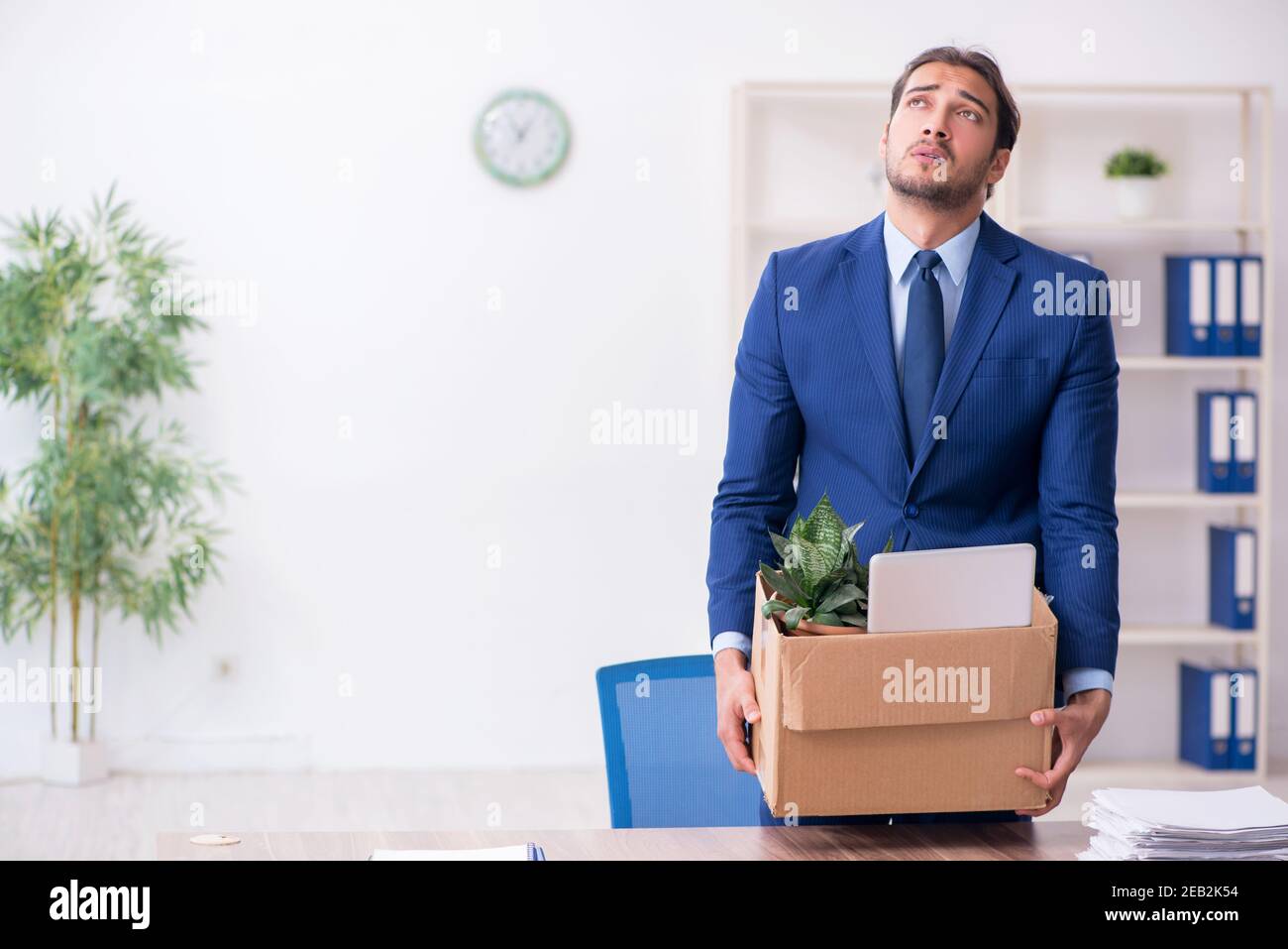 Young man being fired from his workplace Stock Photo - Alamy