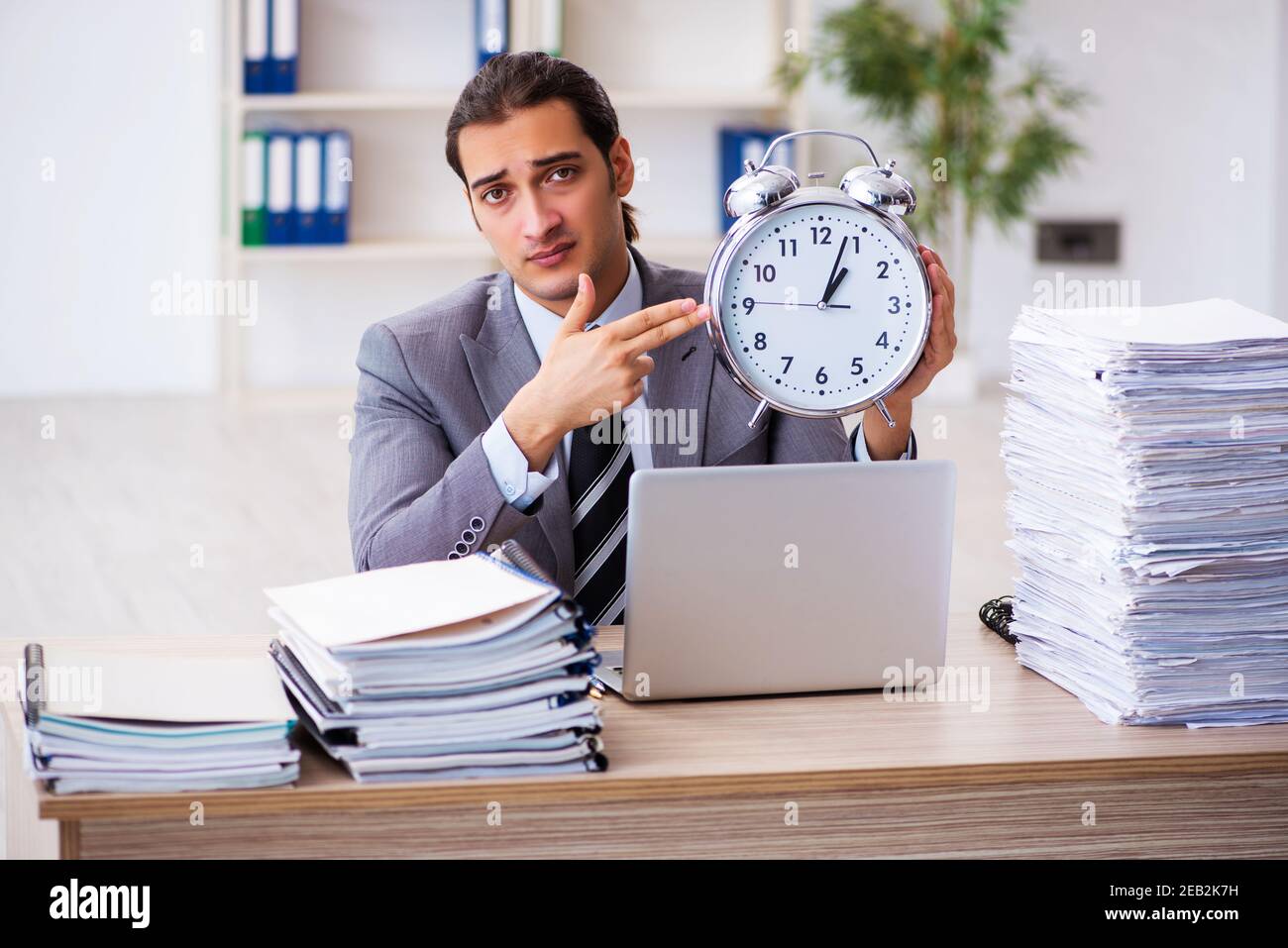 Workload employee in time management concept Stock Photo - Alamy