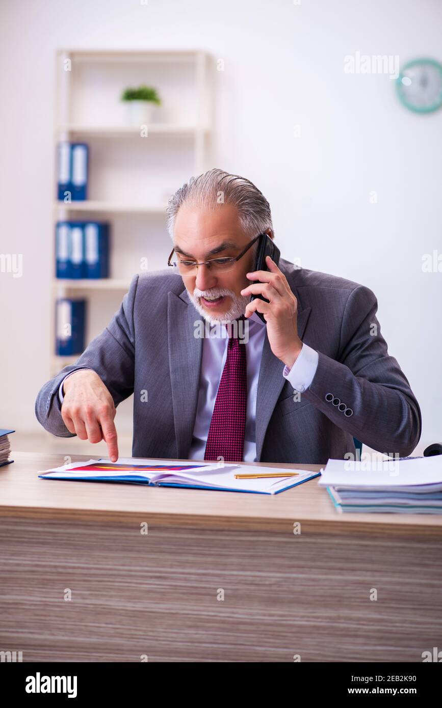 Experienced employee working in the office Stock Photo - Alamy