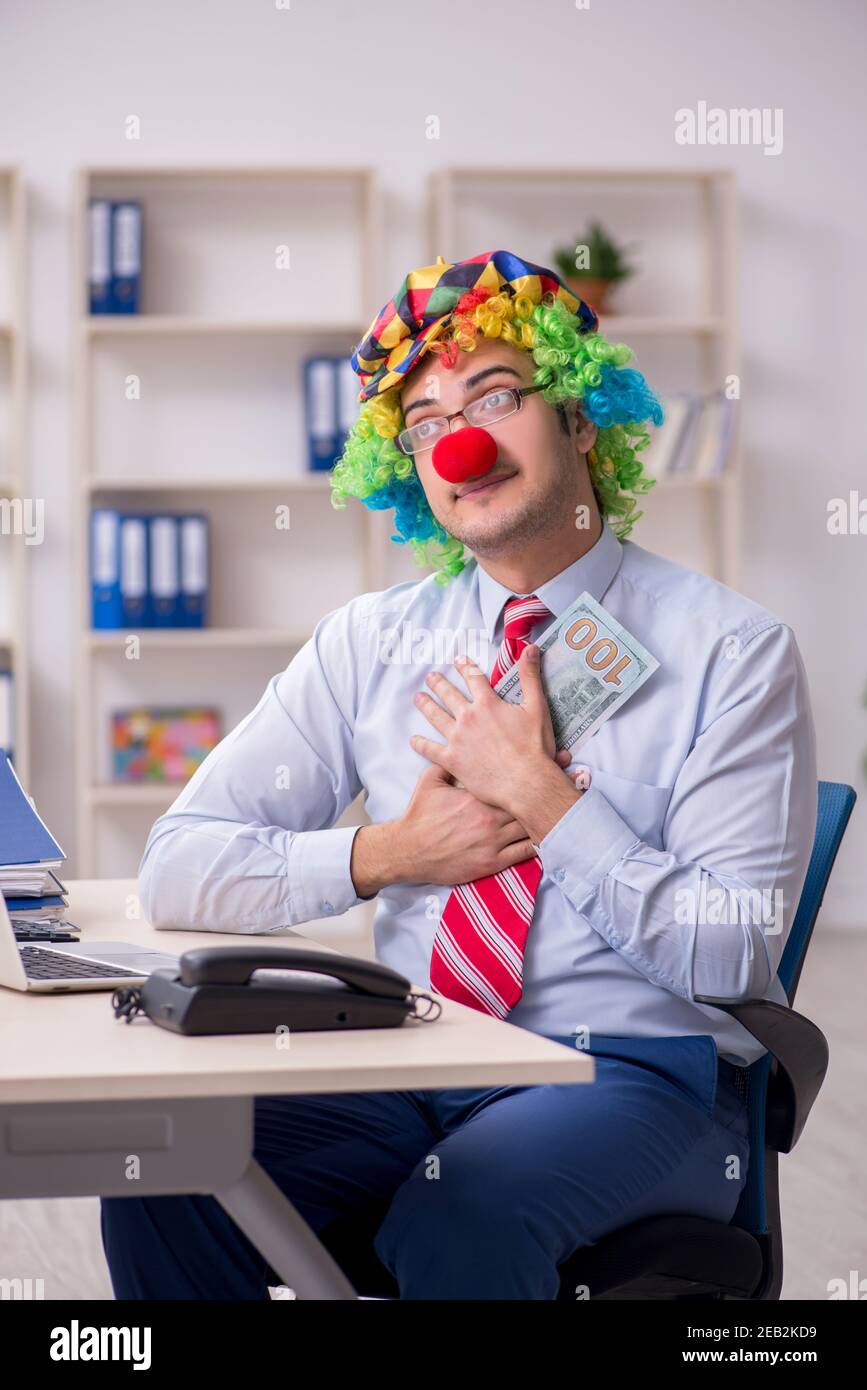Funny employee clown working in the office room Stock Photo - Alamy