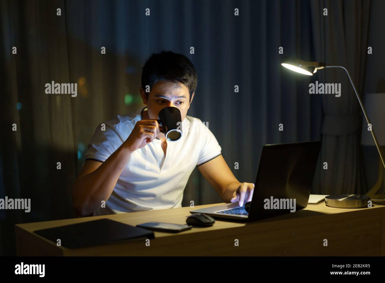 Asian man are drinking tea or coffee while working in late night to ...