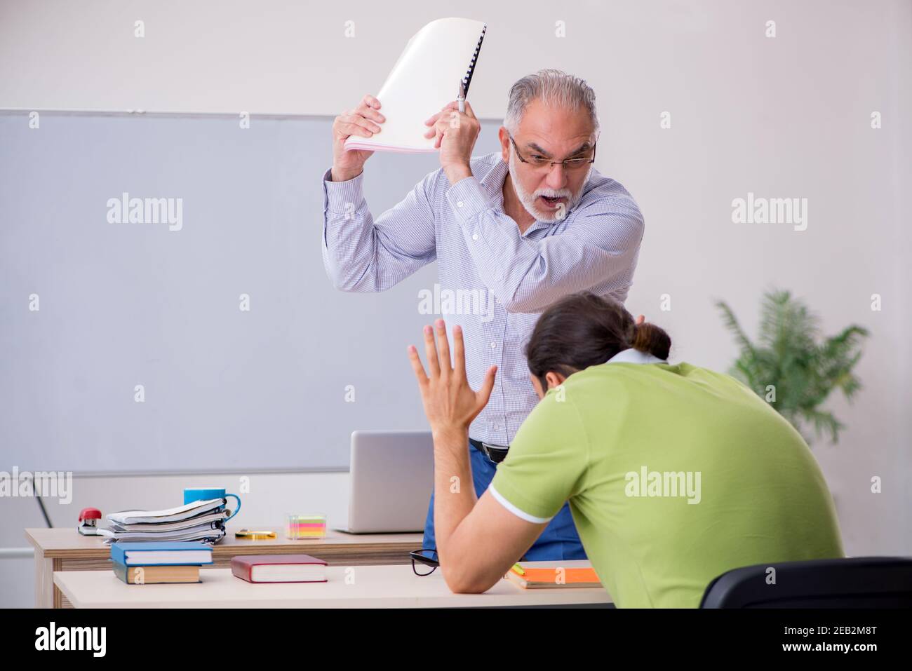 Angry teacher hitting student hi-res stock photography and images - Alamy