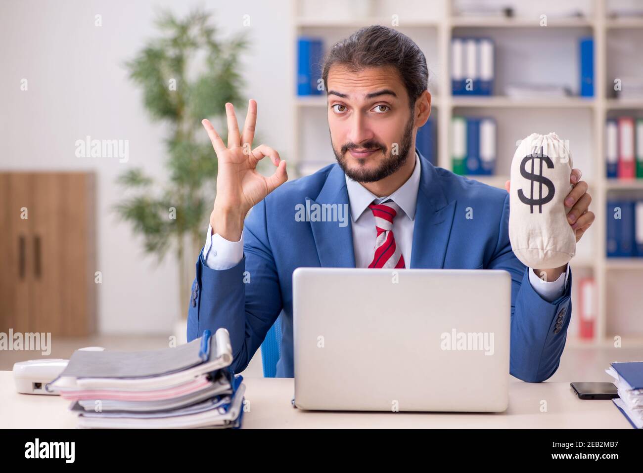 Young employee in remuneration concept Stock Photo - Alamy