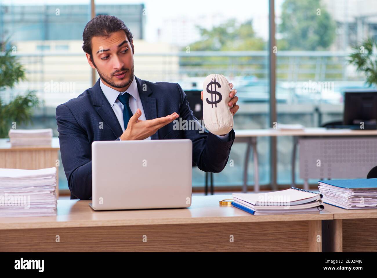 Young businessman employee in remuneration concept Stock Photo - Alamy