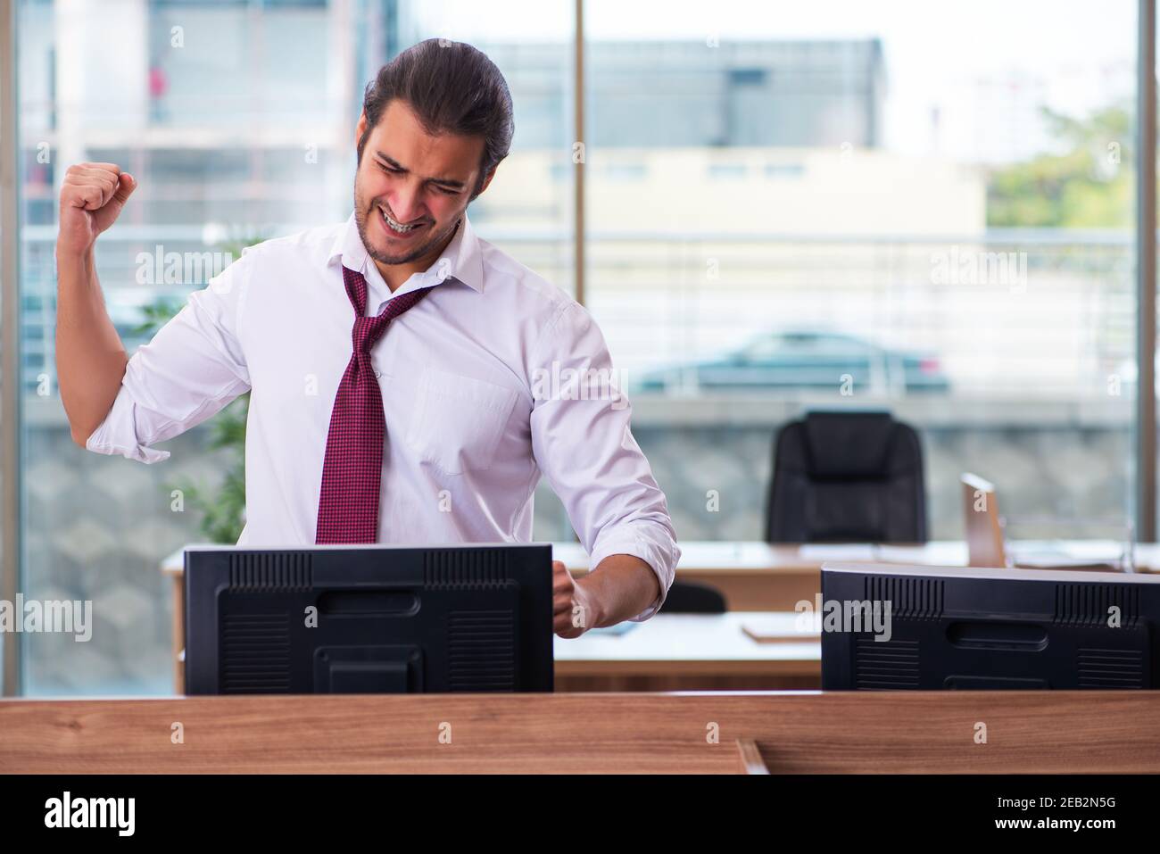 Young employee and too many work in the office Stock Photo - Alamy