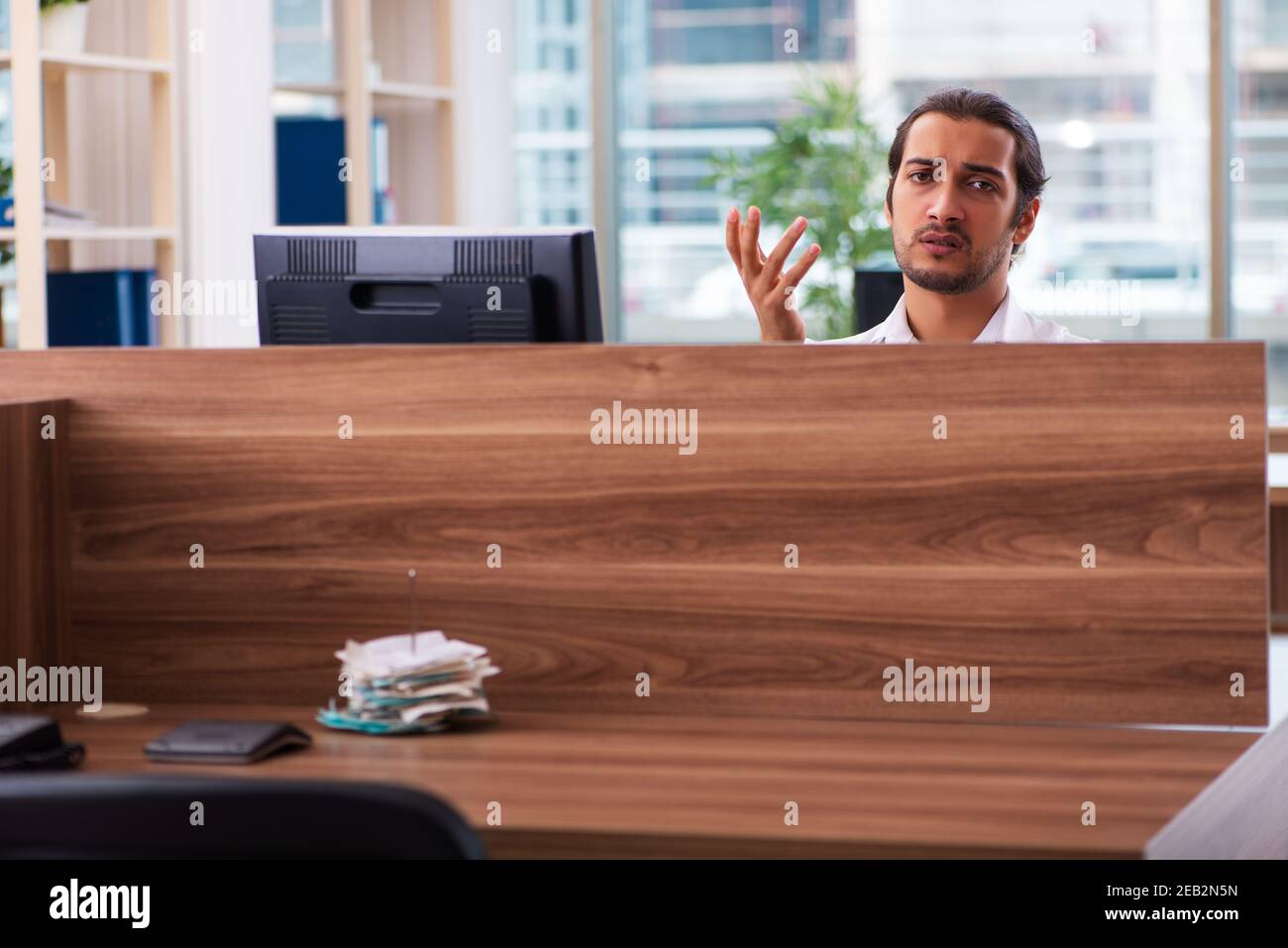 Young employee and too many work in the office Stock Photo - Alamy
