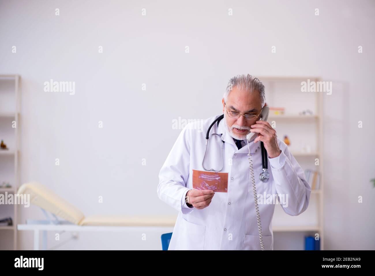 Old male doctor radiologist working in the hospital Stock Photo - Alamy