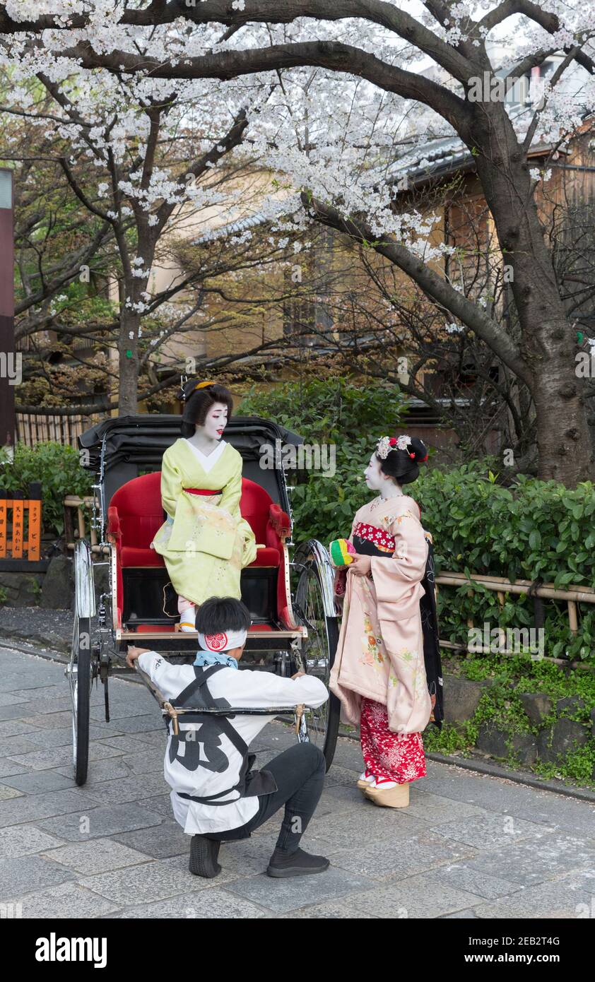 Kyoto Japan Two women dressed as Geisha and a rickshaw driver pose for ...
