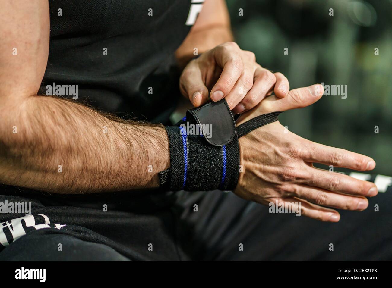 Muscular male bodybuilder wrapping bandages hi-res stock photography ...