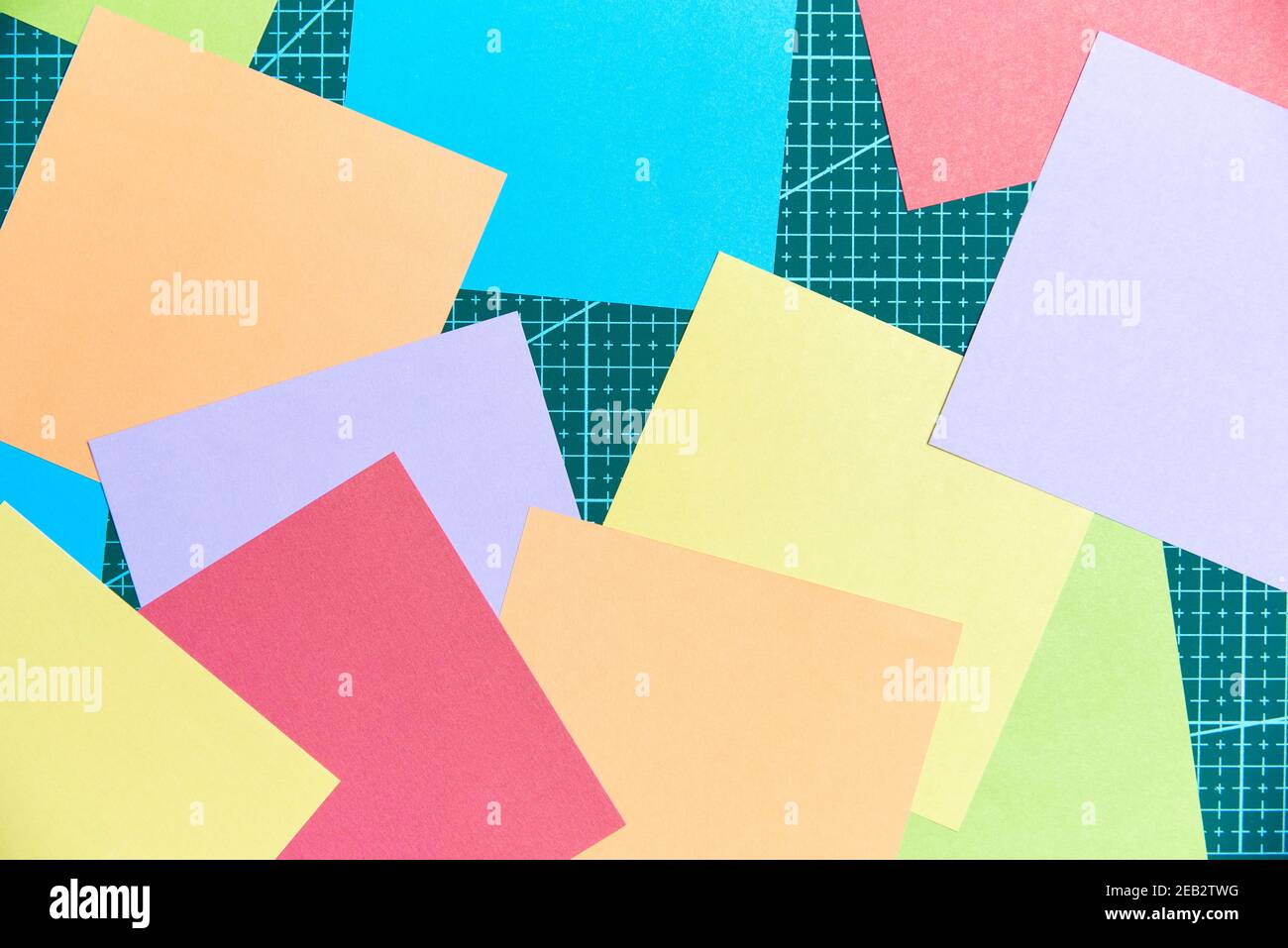 Colorful paper squares on a cutting board. Supplies for origami or ...