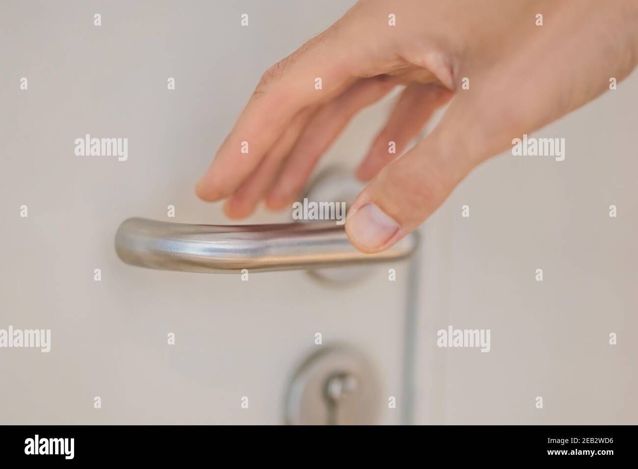 Make hand grab doorknob latch to open steel door to enter building ...