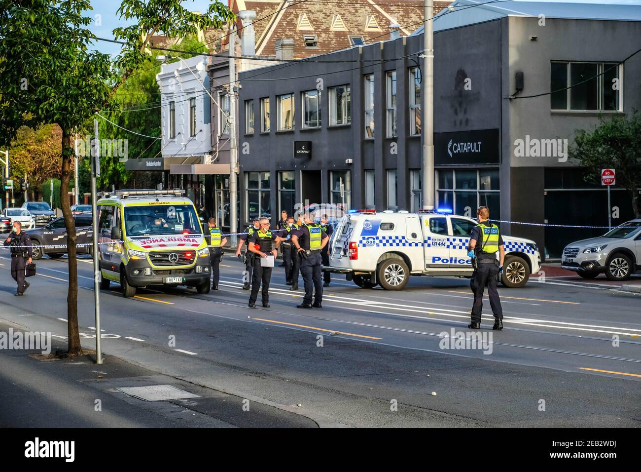 High Street is pictured blocked by police officers as an ambulance ...