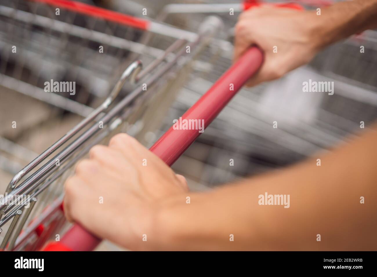 men hand push shopping cart ,supermarket , abstract blurred photo of ...