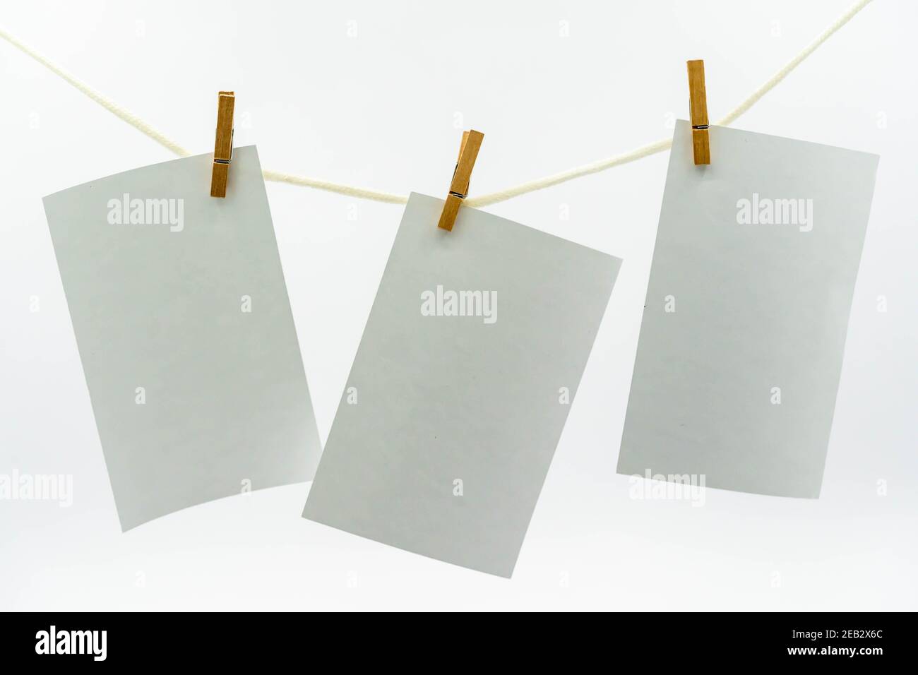 Multiple empty paper sheet for notes that hang on a rope with ...