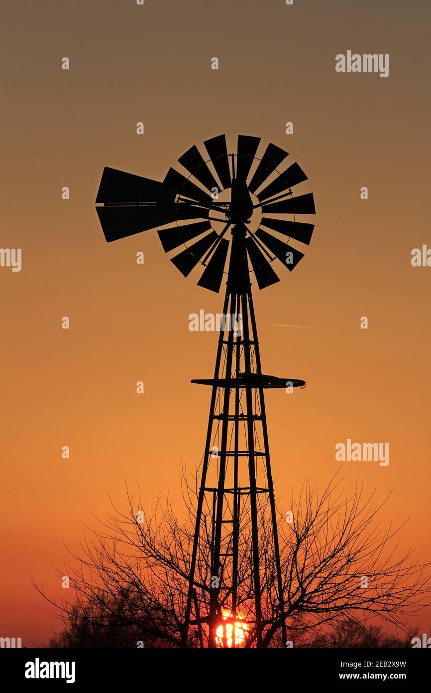 Kansas Windmill Silhouette with tree's and a colorful sky out in the ...