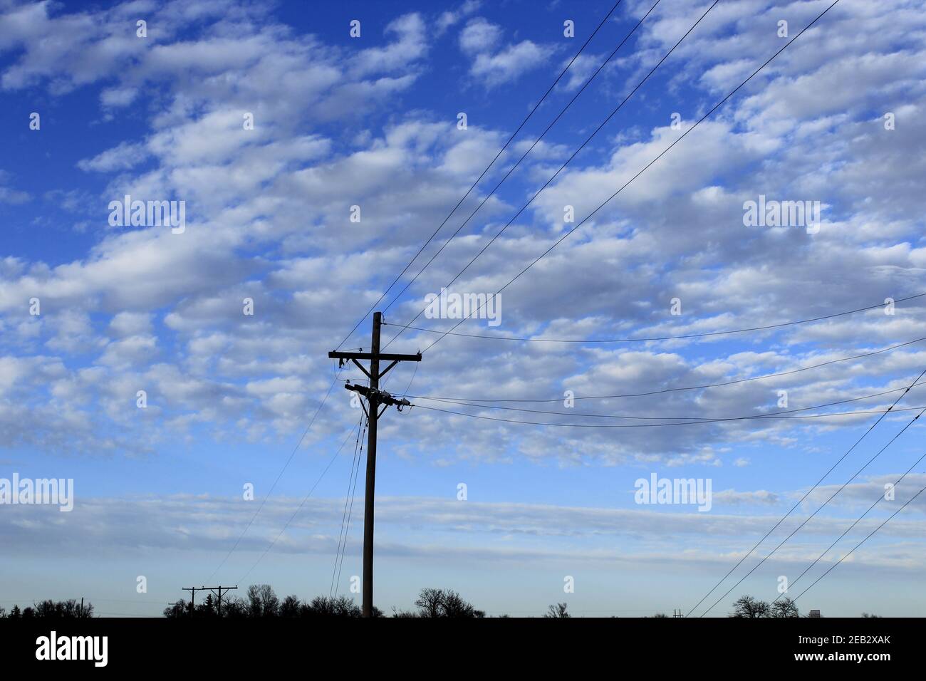 Kansas blue sky and white clouds with power lines out in the country ...