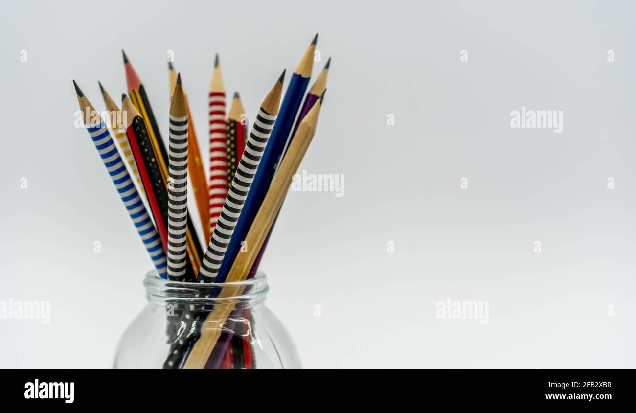 Pencils in a pencil bucket on white background. Back to school concept ...
