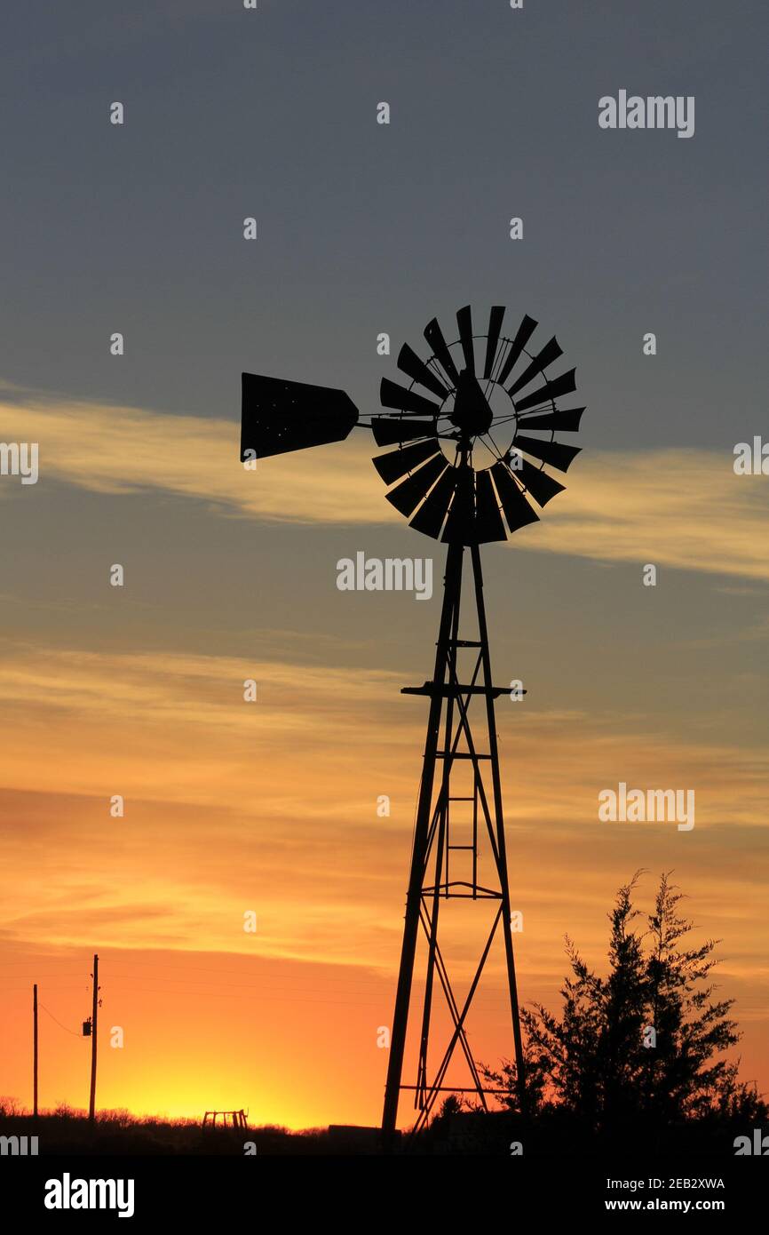 Kansas Sunset with a colorful sky and cloud's with a Windmill and tree ...