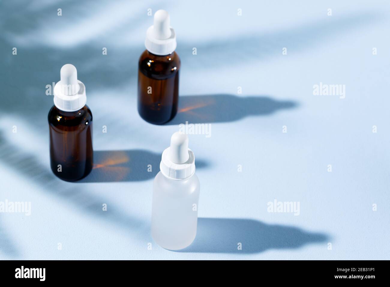 Glass jar with skincare liquid on gray background with shadow Stock ...