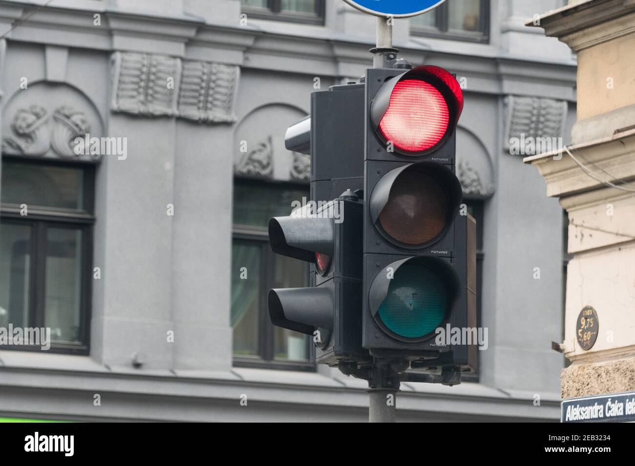 Red traffic light on the background of the city. City street traffic ...