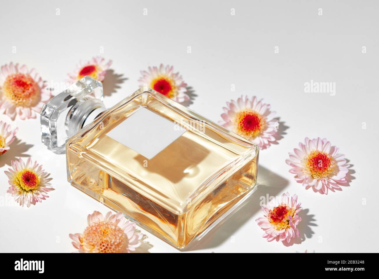 Bottle of fragrance surrounded by flower buds Stock Photo - Alamy