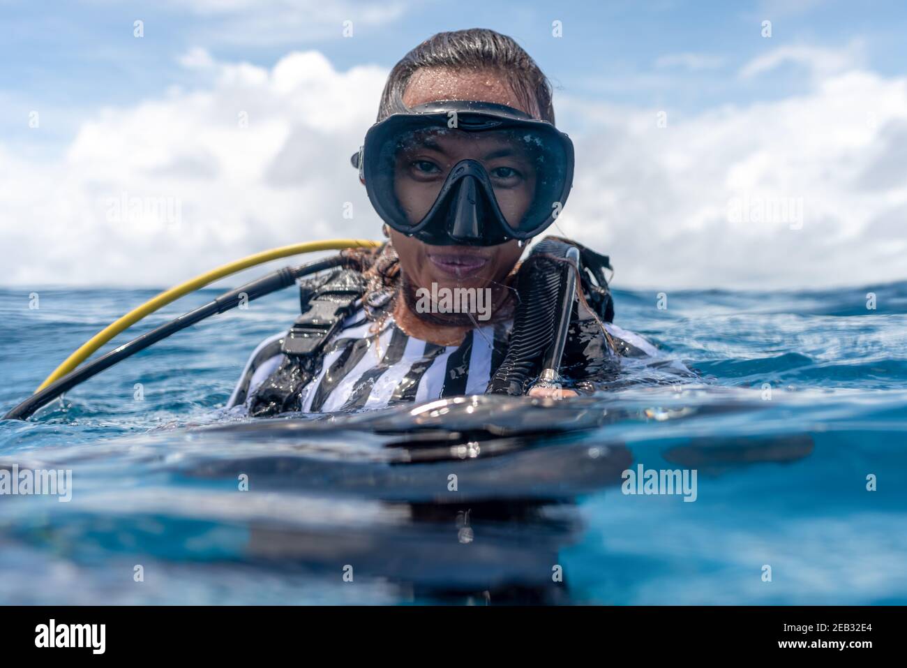 Scuba diving girl in blue ocean open water and blue sky Stock Photo - Alamy