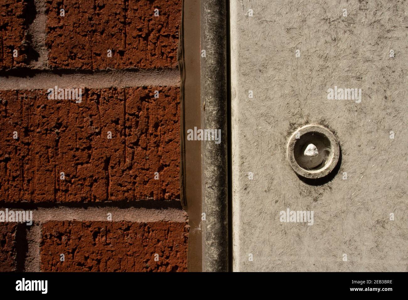 detail of a gas meter box cover and lock with red bricks, mould and ...