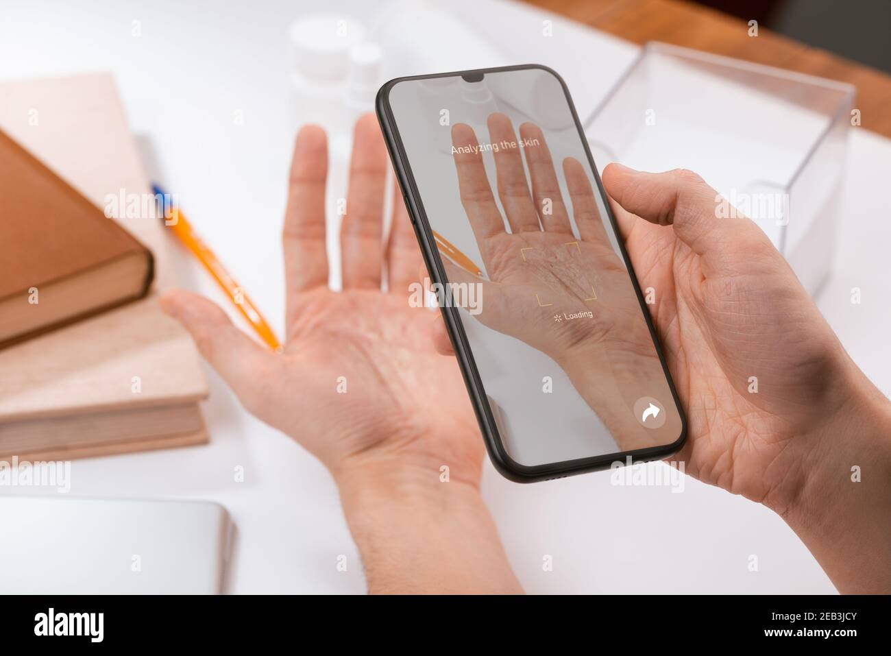 Man using a phone app to recognize the disease on his palm Stock Photo ...