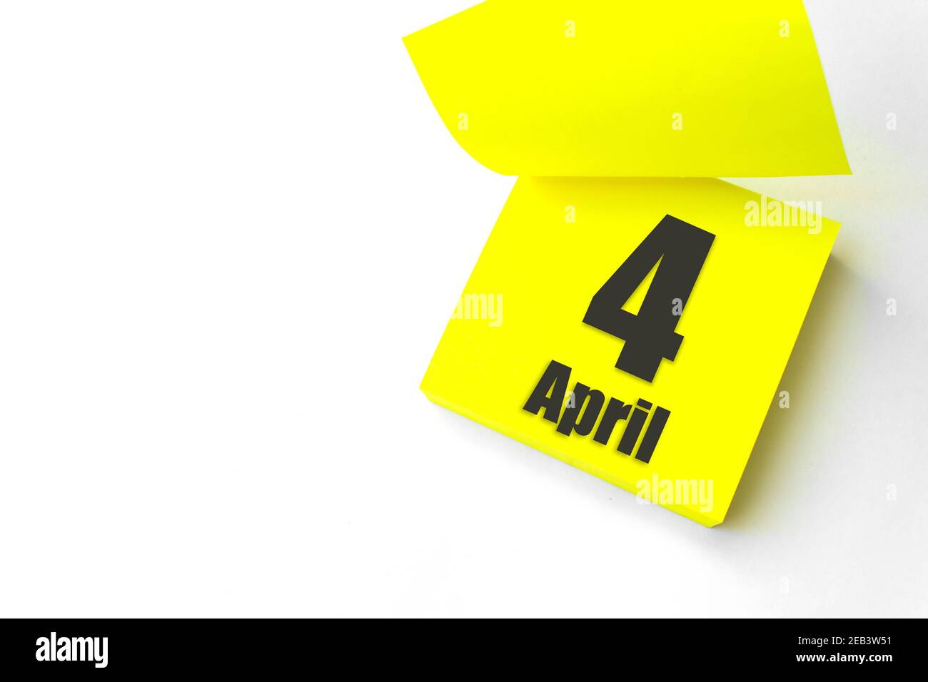 April 4th. Day 4 of month, Calendar date. Close-Up Blank Yellow paper ...