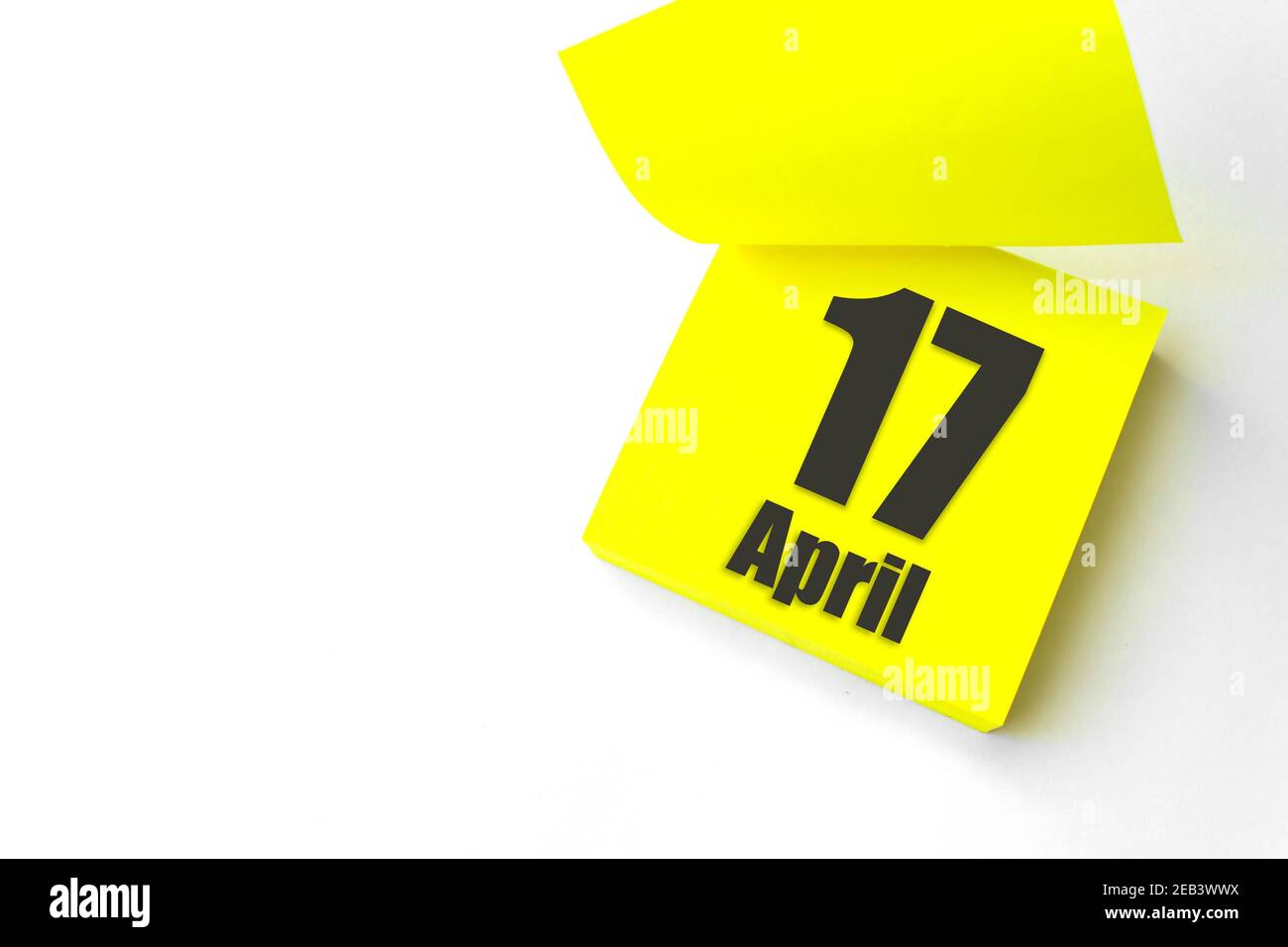 April 17th. Day 17 of month, Calendar date. Close-Up Blank Yellow paper ...