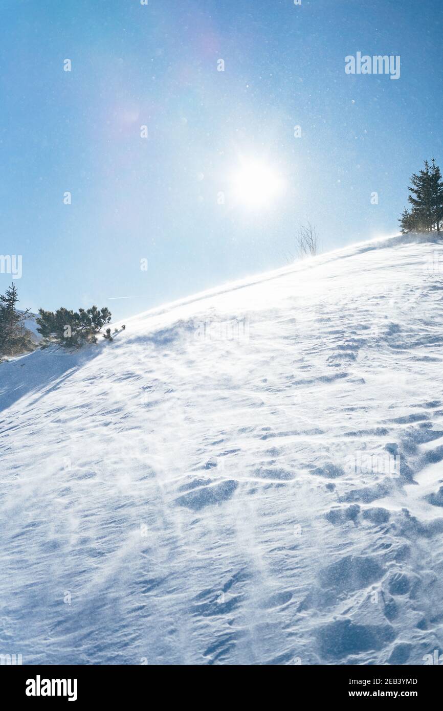 Blowing snow over snowy surface on top of mountain in Switzerland ...