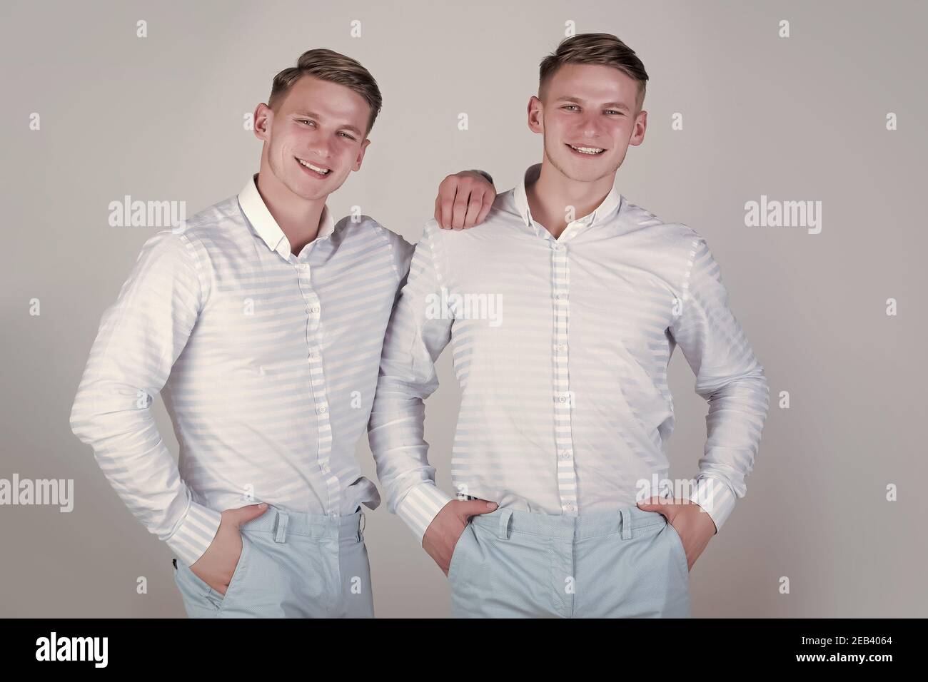 Brothers and friendship concept. Happy men hugging. Models standing ...
