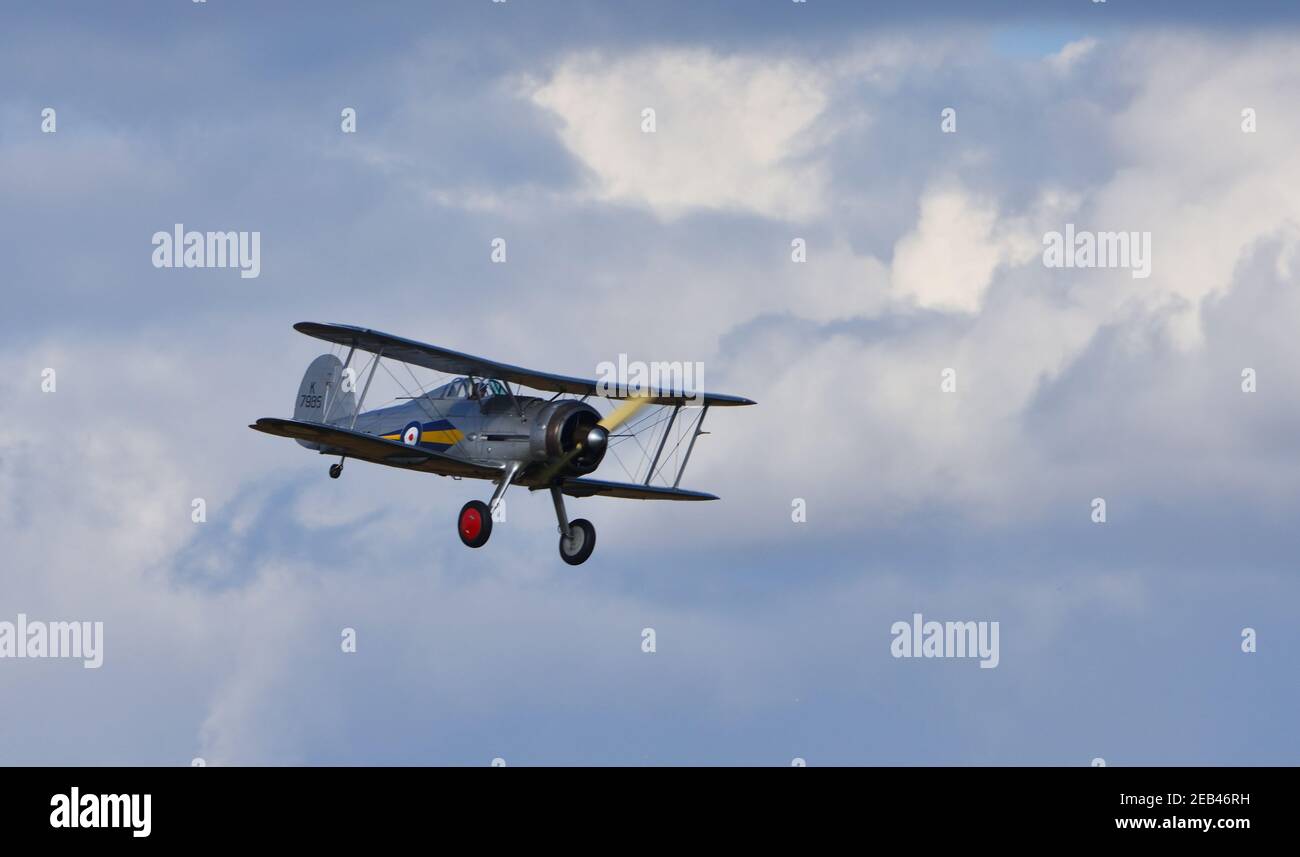 Gloster Gladiator aircraft in flight with cloud and blue sky background ...