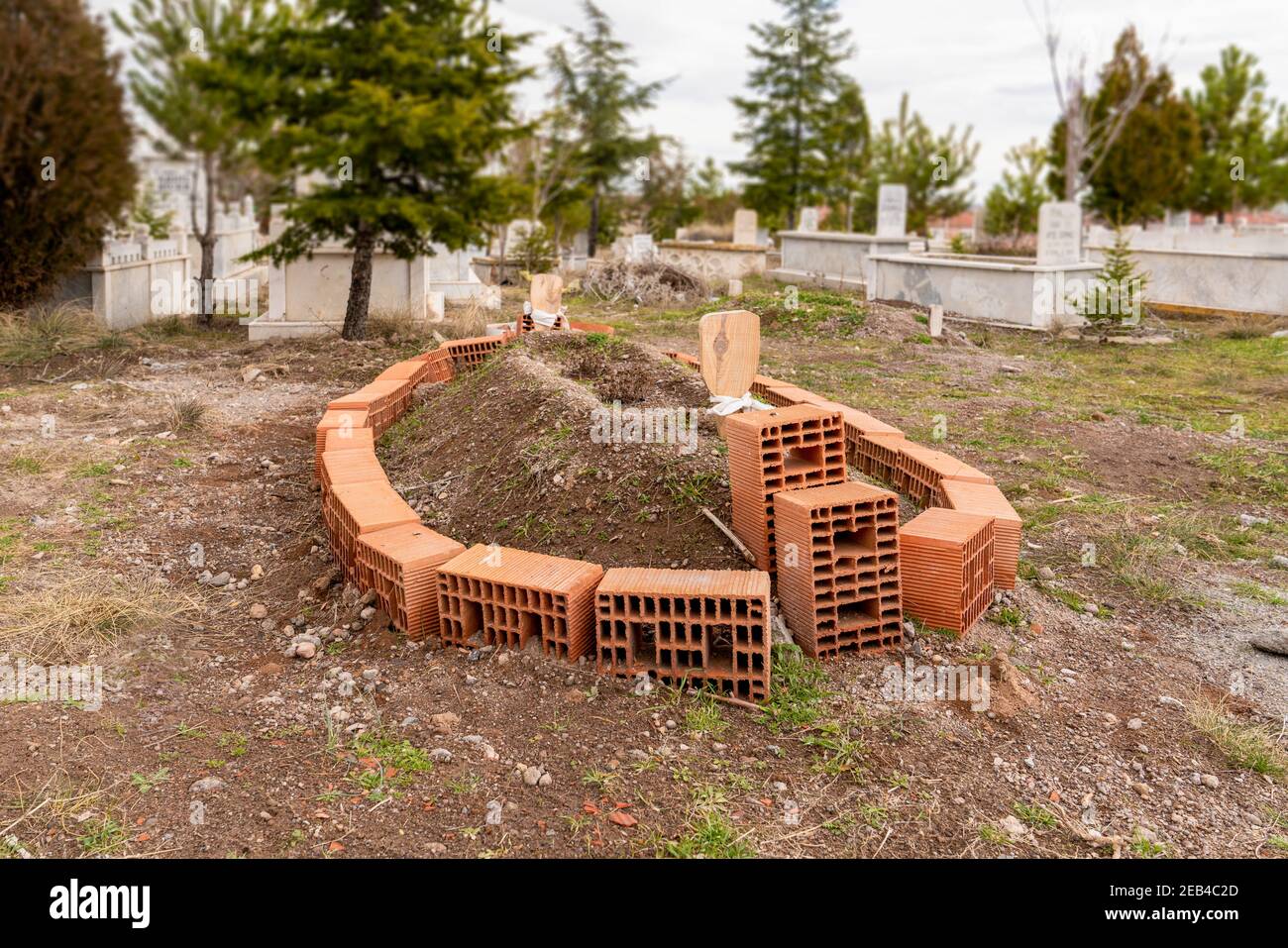 Tomb temporarily made of red brick after burial. A marble grave will be ...
