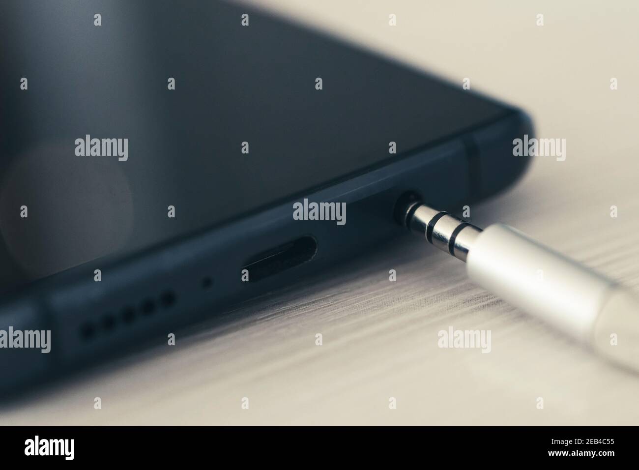 Connection 3.5 mm audio jack to a black mobile phone Stock Photo - Alamy