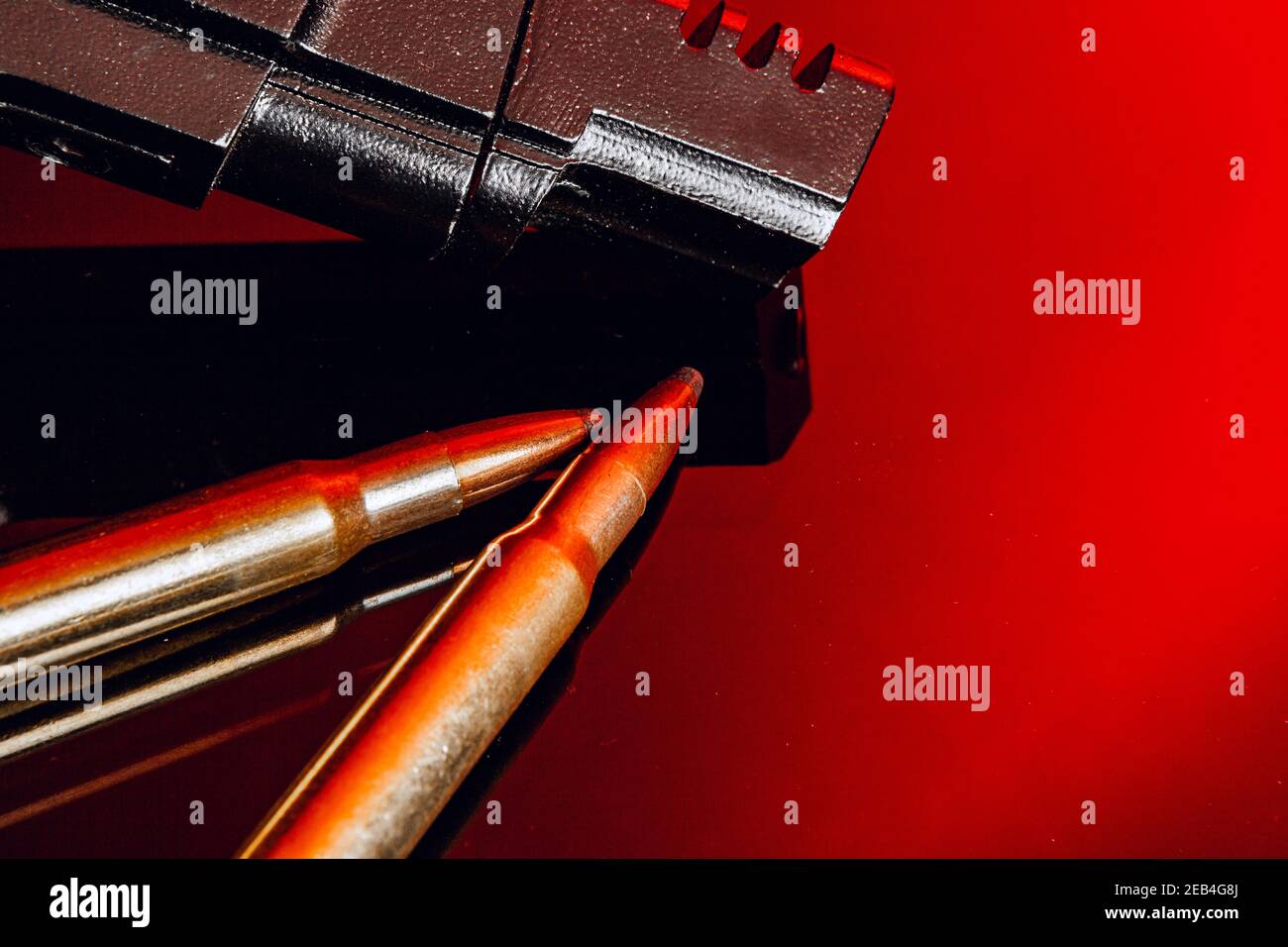 Black gun and cartridges on background with red reflection Stock Photo ...