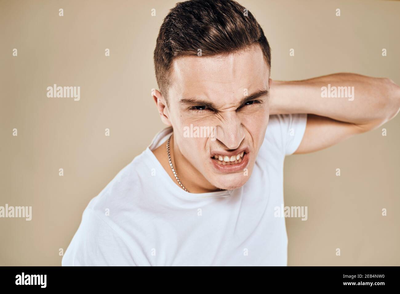 Man with displeased facial expression emotions white t-shirt gestures ...