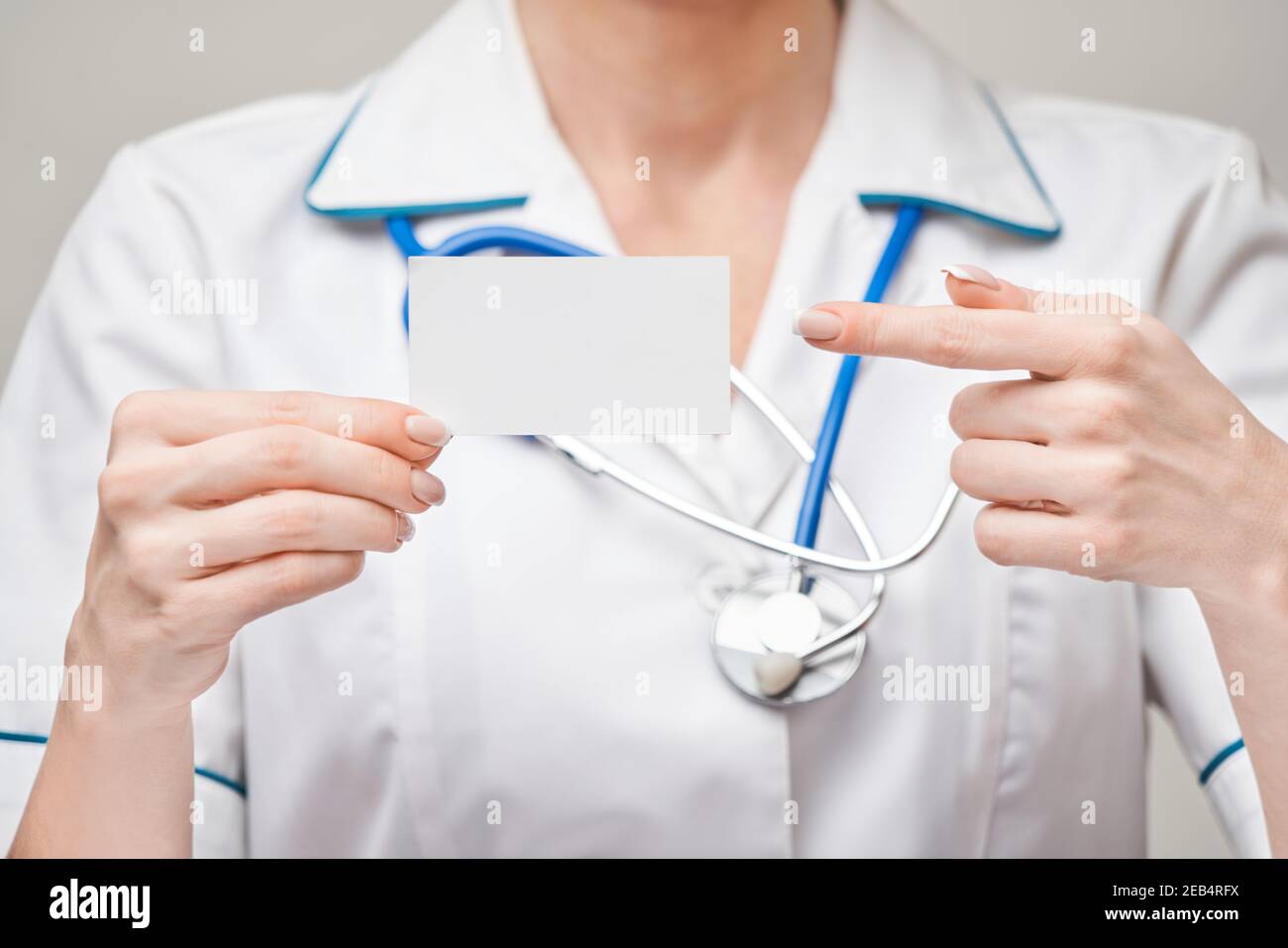Medical worker doctor or nurse showing blank business card sign with ...