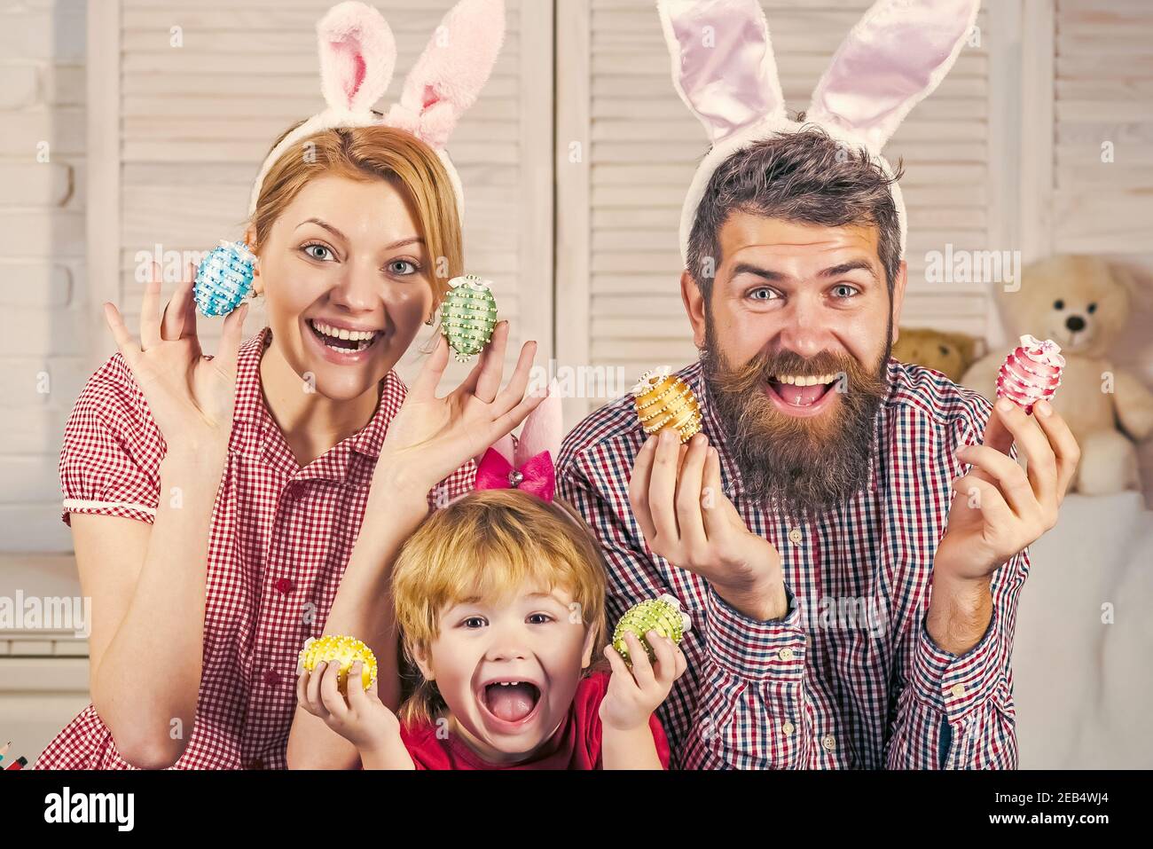 Happy easter family with paint eggs. Mother, father and son child in ...