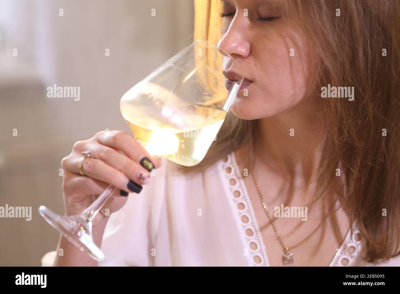 Girl drinking white wine Stock Photo - Alamy