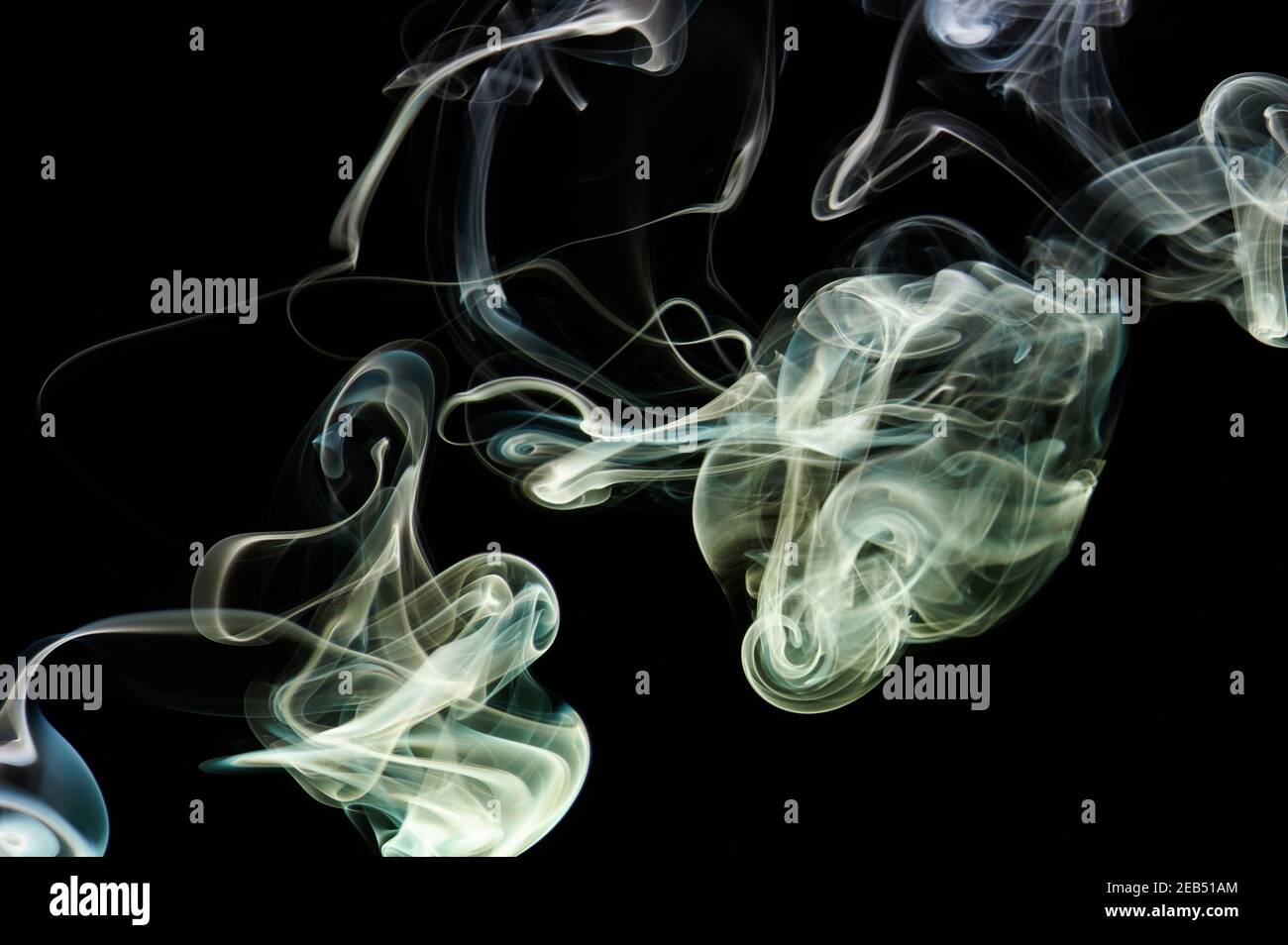 Abstract colorful smoke curl with smooth shape in black backdrop Stock ...
