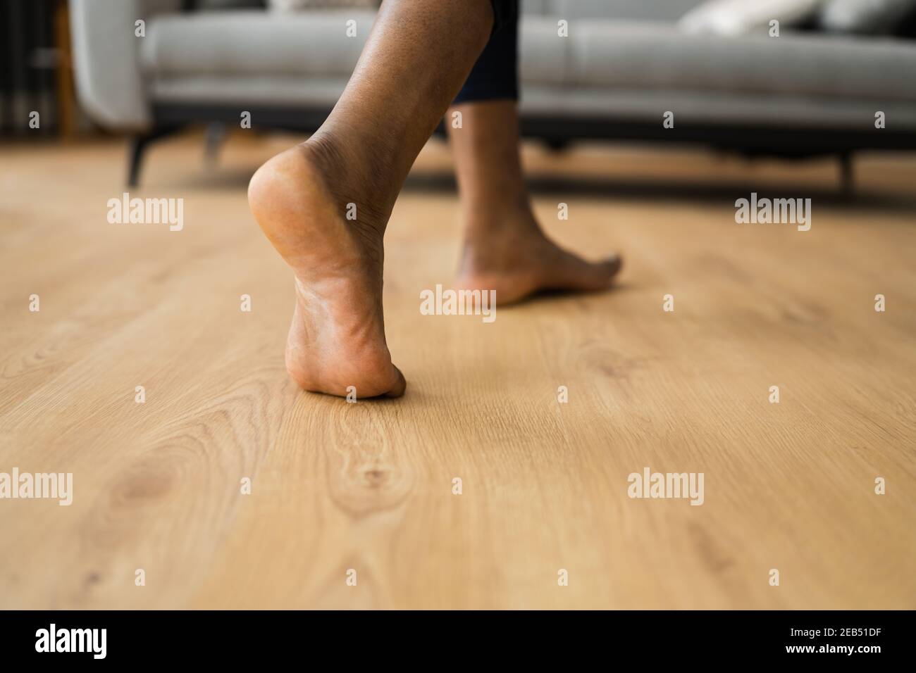 African Barefoot Woman Walking On Heated Floor In Living Room Stock ...