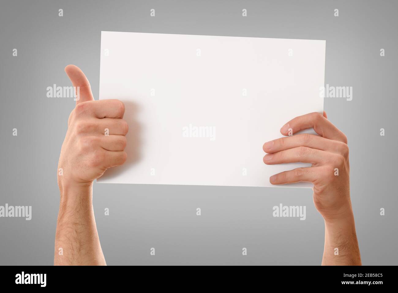 Hands holding poster template hi-res stock photography and images - Alamy