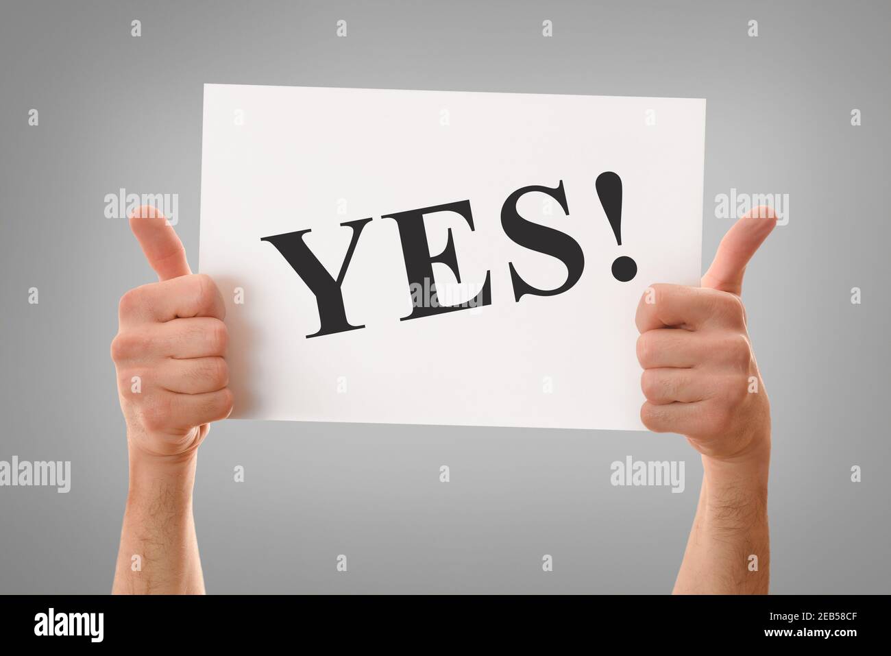 Two hands holding white sheet horizontally and both with fingers with ...